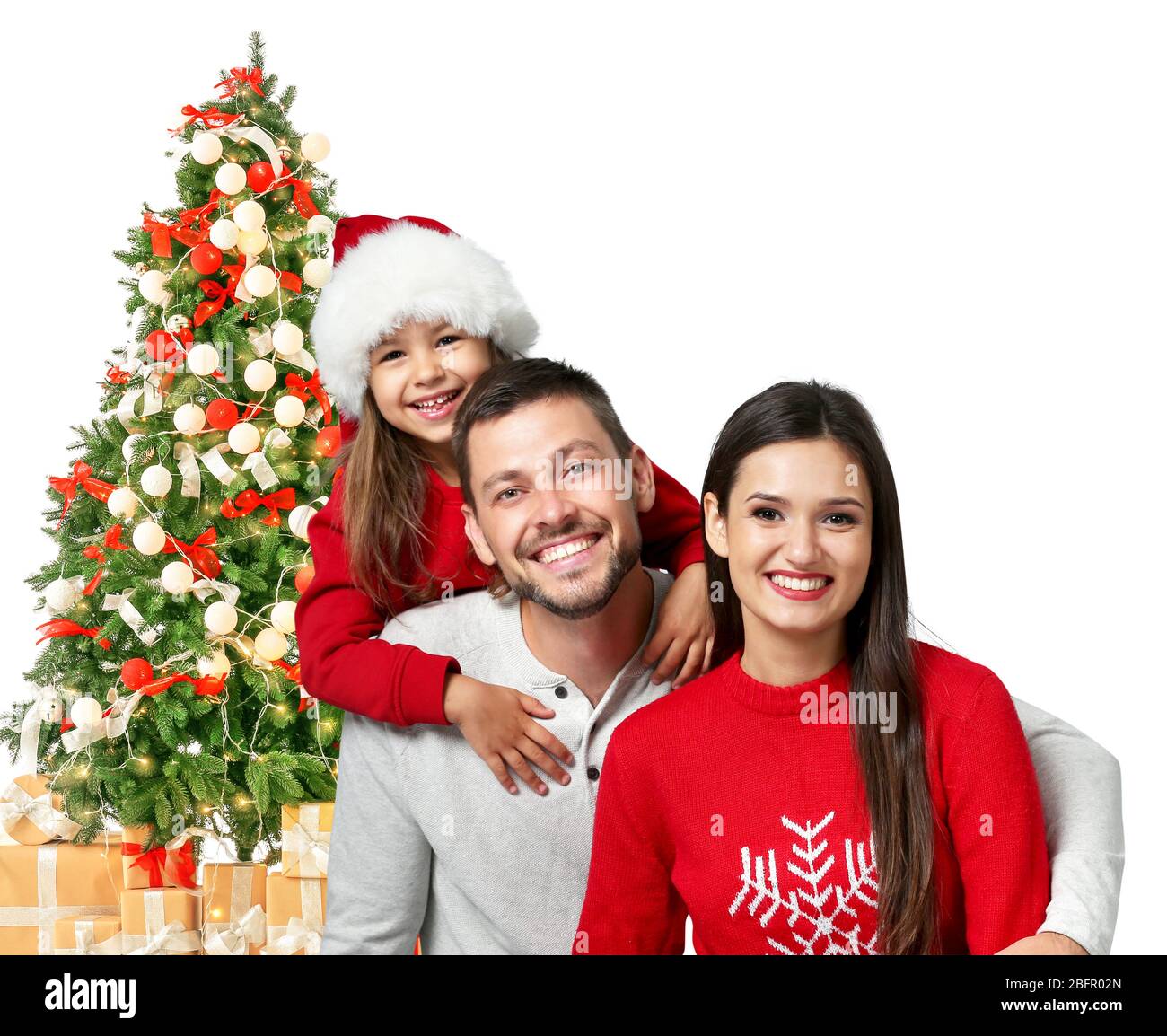 Happy family with gift boxes and decorated Christmas tree on white ...