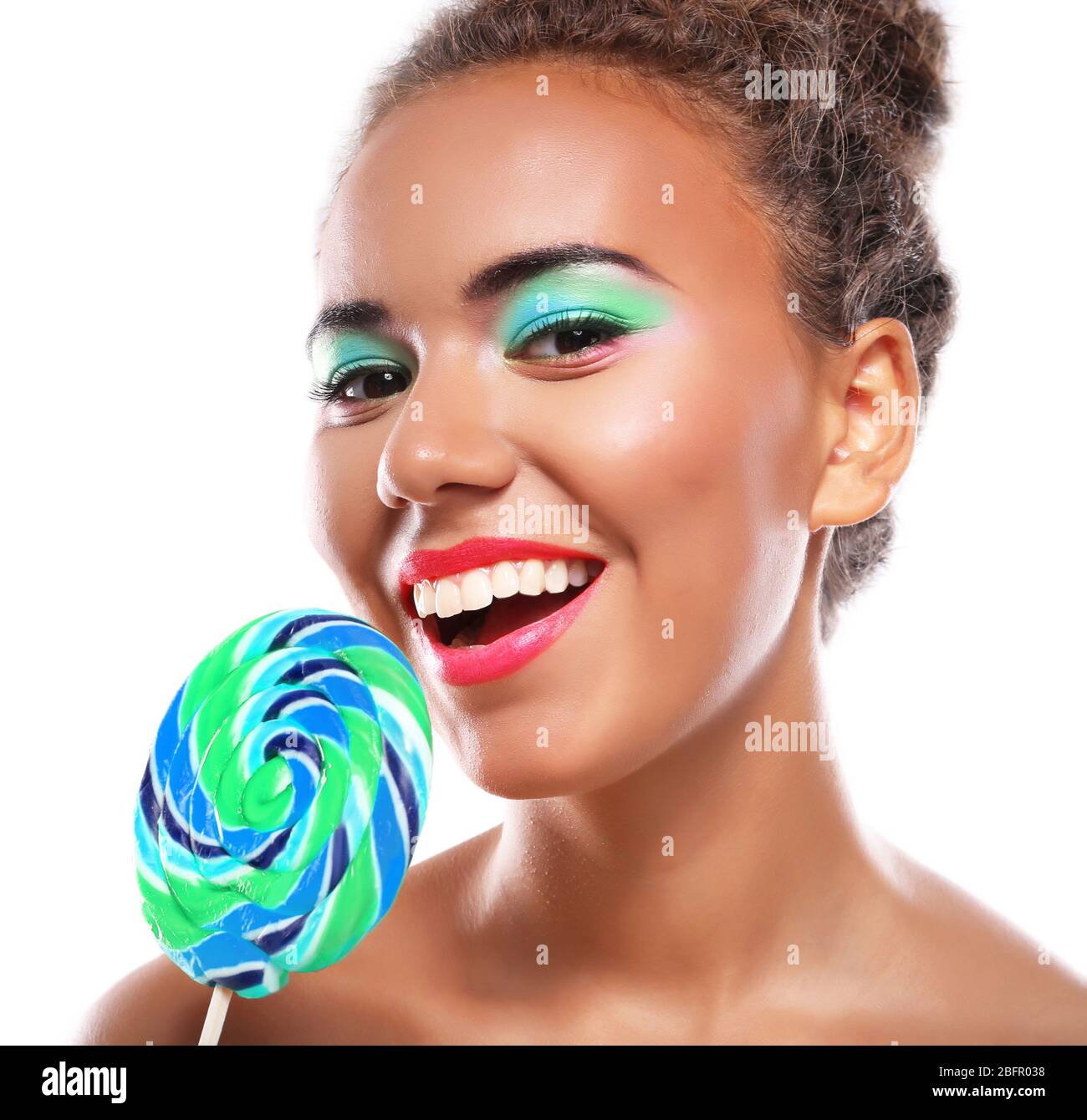 Beautiful young woman with colourful lollipop on white background Stock ...