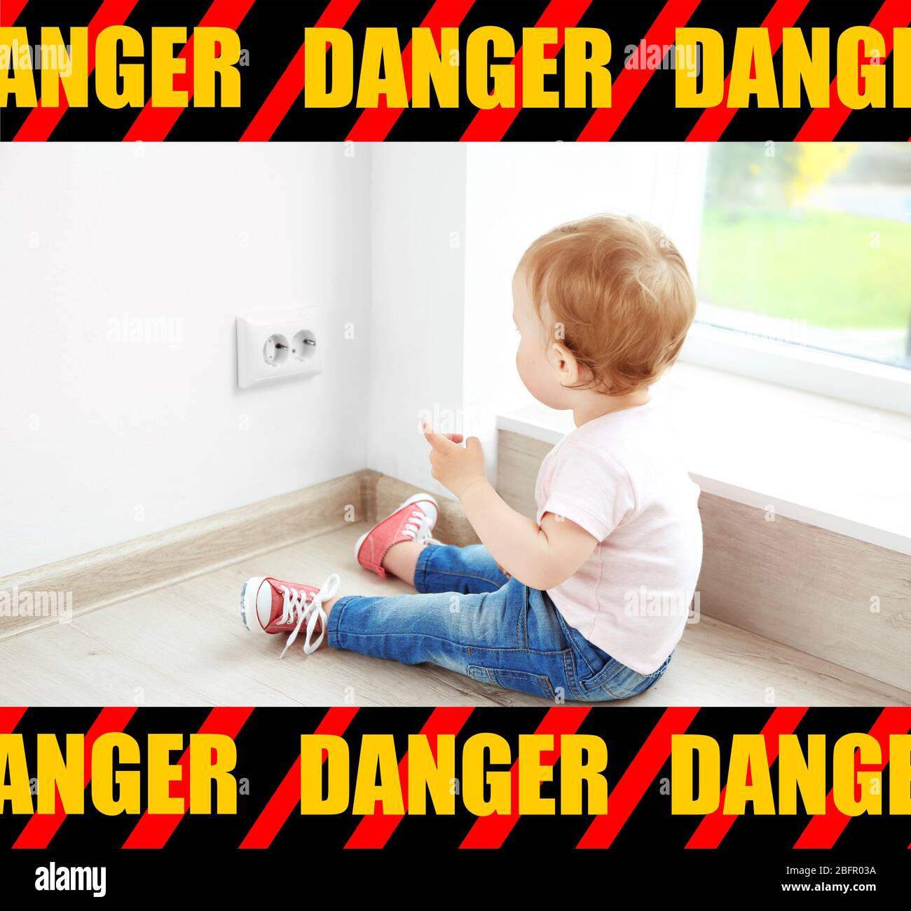 Baby playing with electrical outlet at home Stock Photo - Alamy