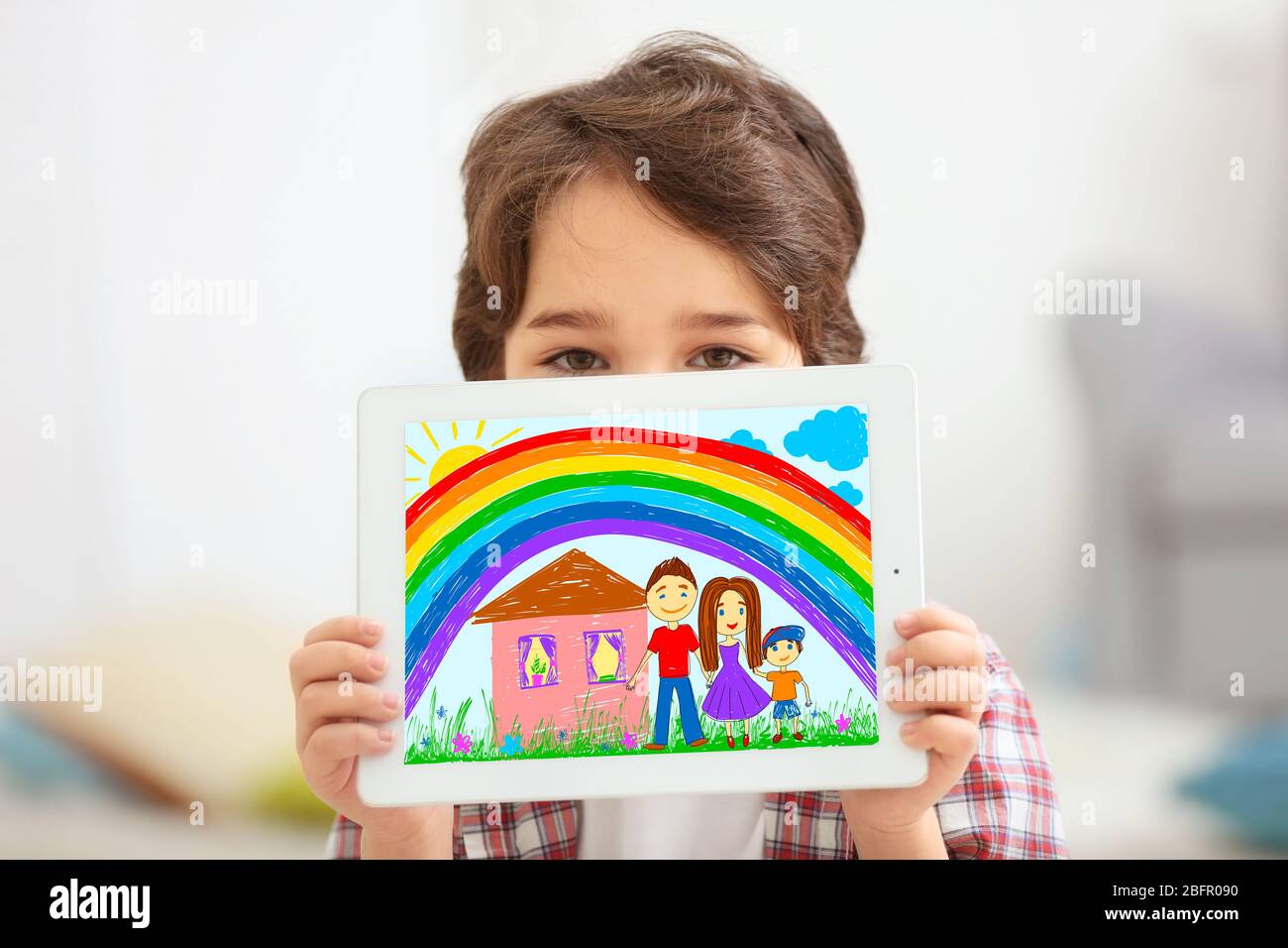 Little boy showing his drawing on tablet at home Stock Photo - Alamy