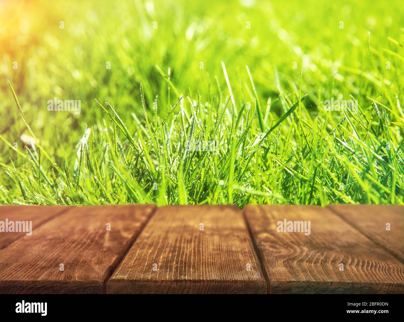 Wooden table and green grass on background Stock Photo - Alamy