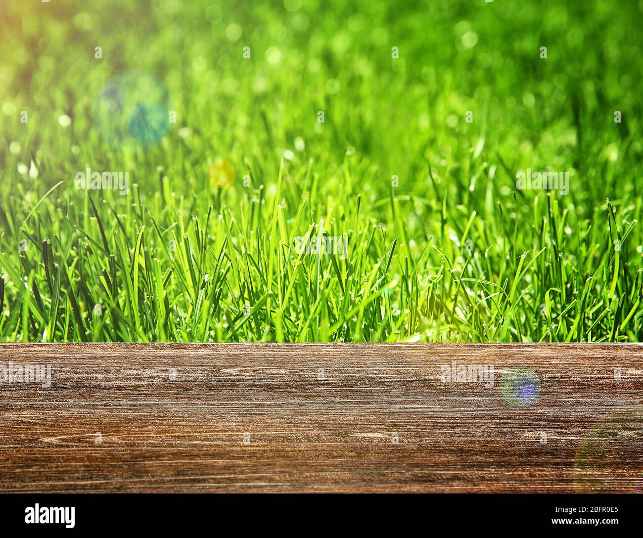 Wooden table and green grass on background Stock Photo - Alamy
