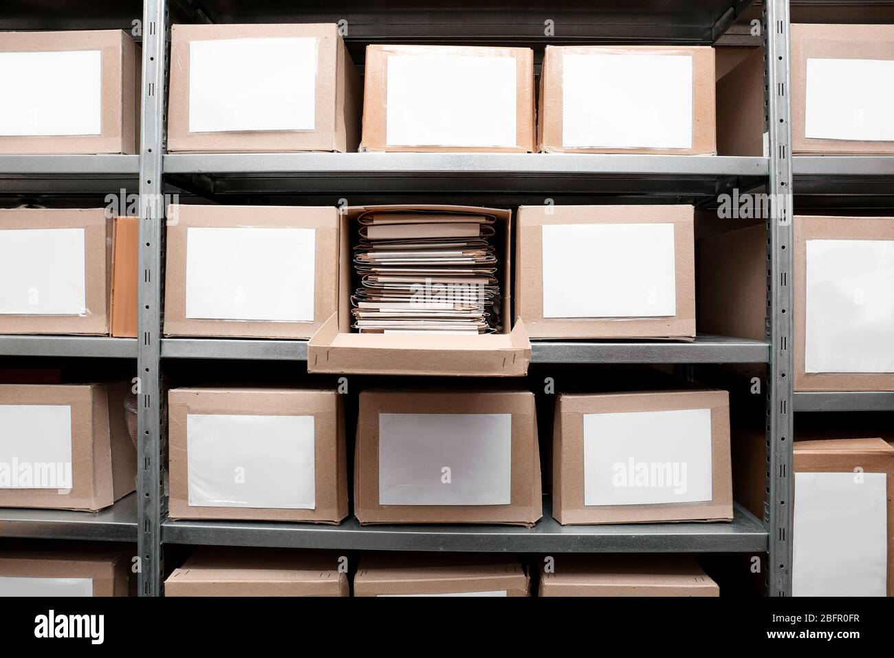 Cardboard boxes with documents on shelving unit in archive Stock Photo ...