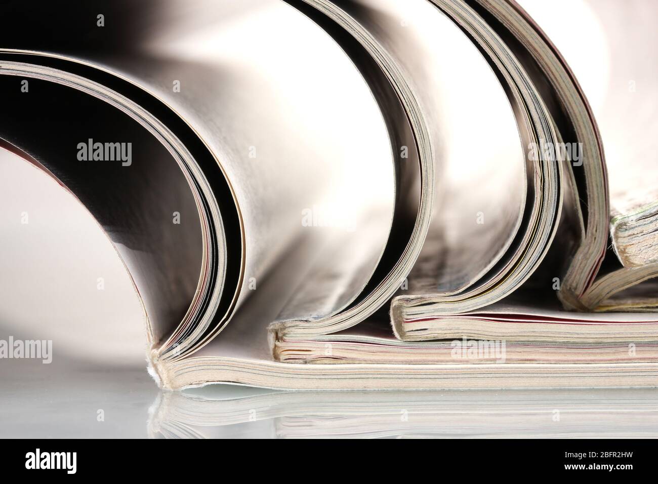 open magazines isolated on white Stock Photo - Alamy