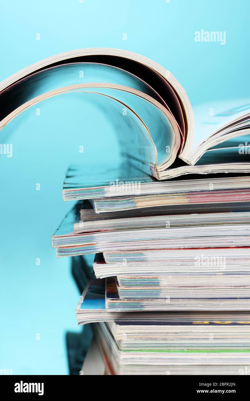 stack of magazines on blue background Stock Photo - Alamy