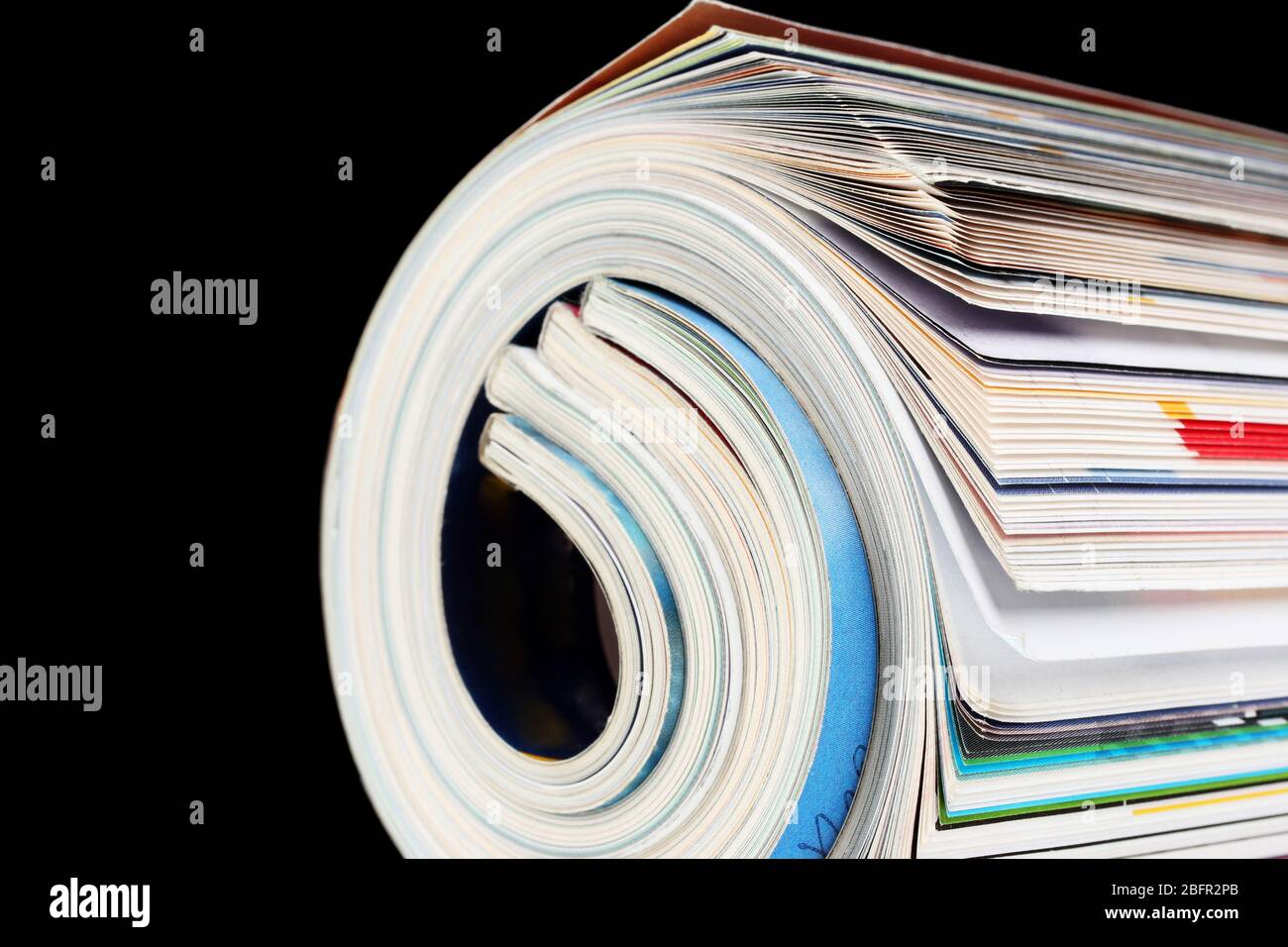 Rolled up magazines on gray background Stock Photo - Alamy