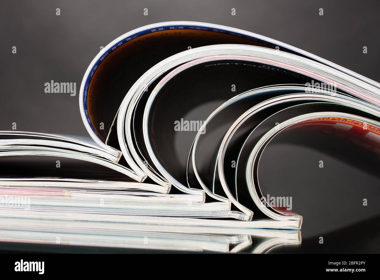 open magazines on gray background Stock Photo - Alamy