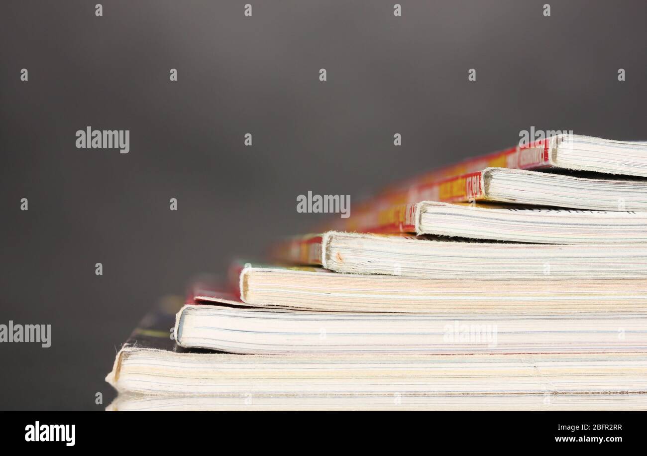 stack of magazines on gray background Stock Photo - Alamy