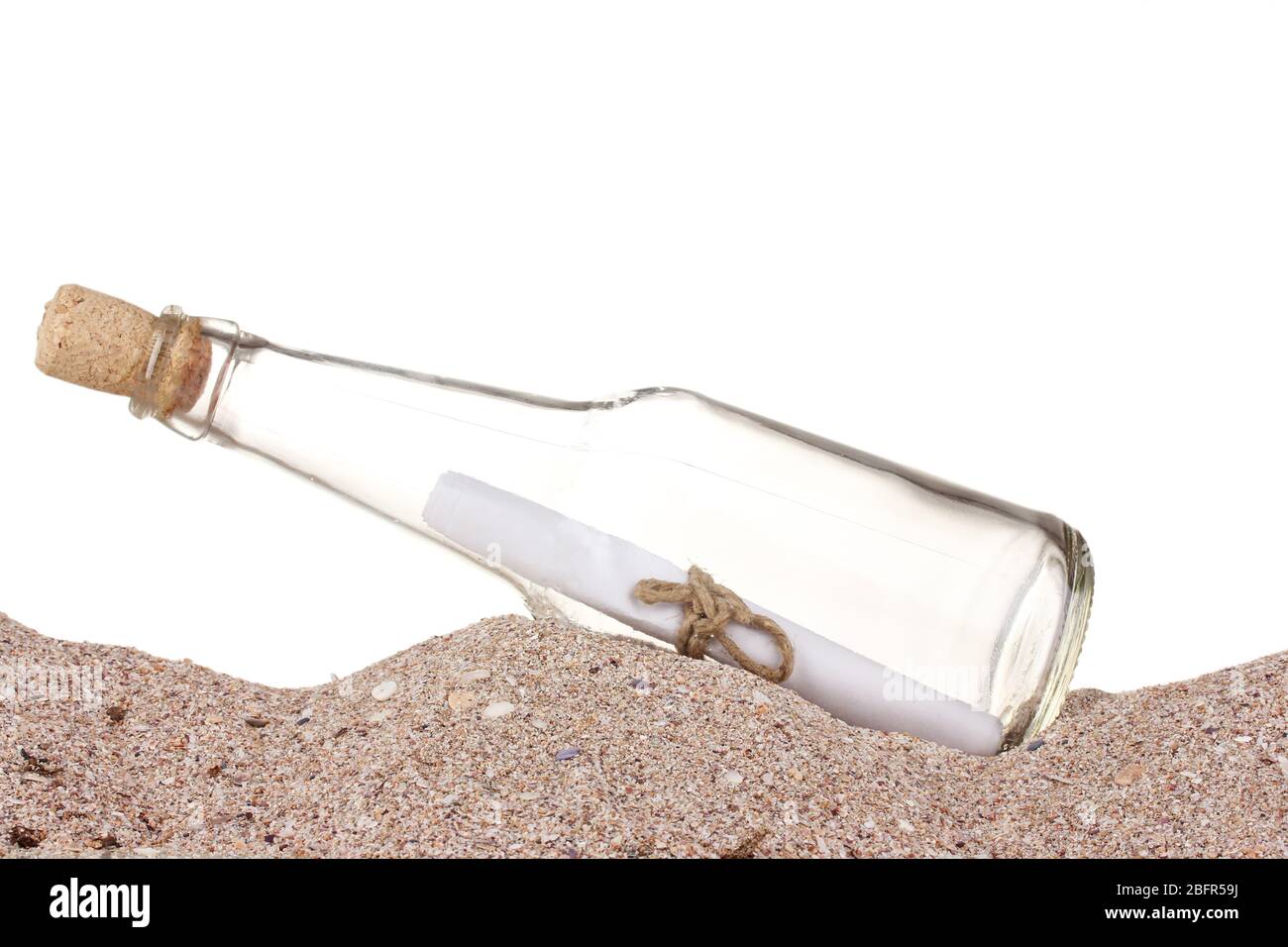 Glass bottle with note inside on sand on white background Stock Photo ...