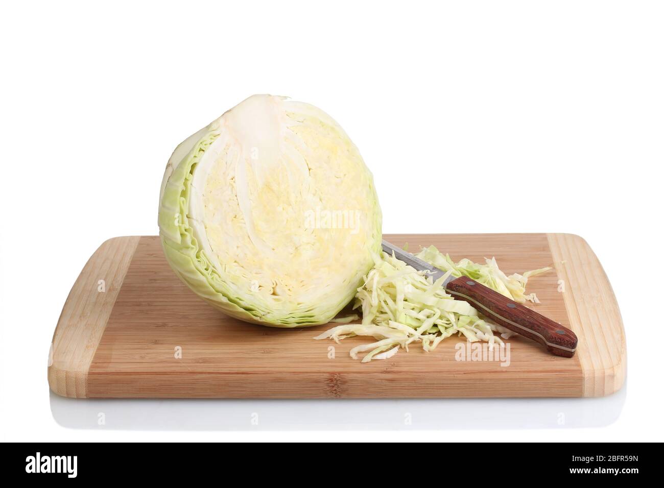 green cabbage shredded on wooden board isolated on white Stock Photo ...