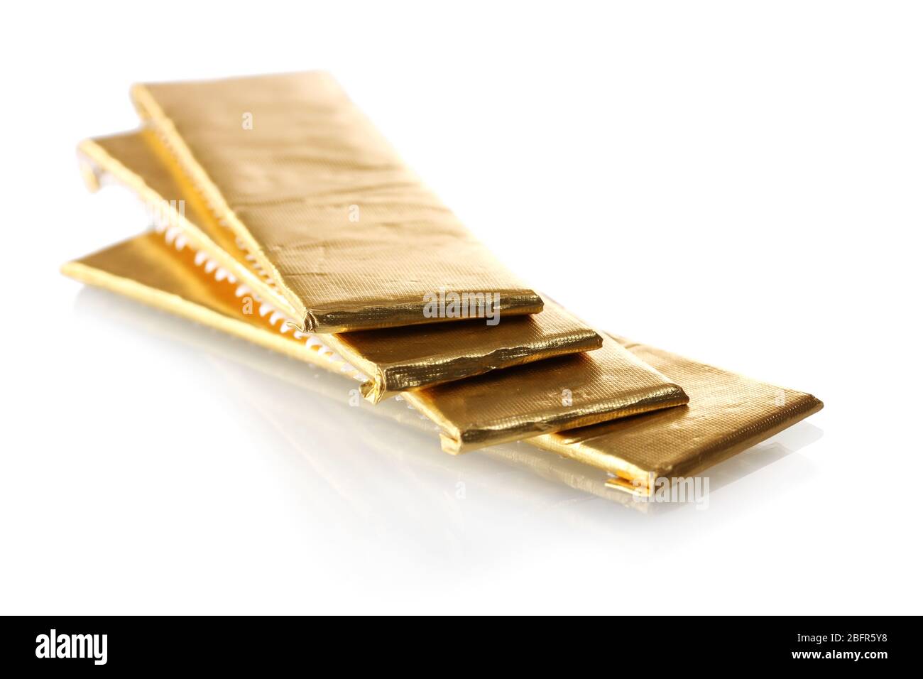 chewing gums wrapped in golden foil, isolated on white Stock Photo - Alamy