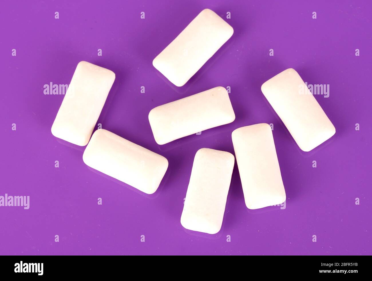 Chewing gums on purple background Stock Photo - Alamy
