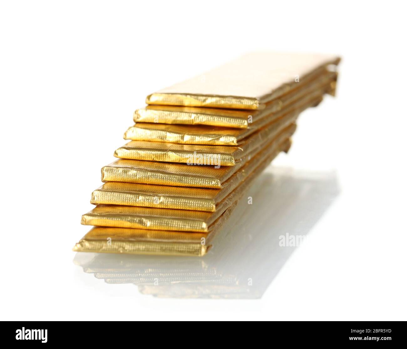 chewing gums wrapped in golden foil, isolated on white Stock Photo - Alamy