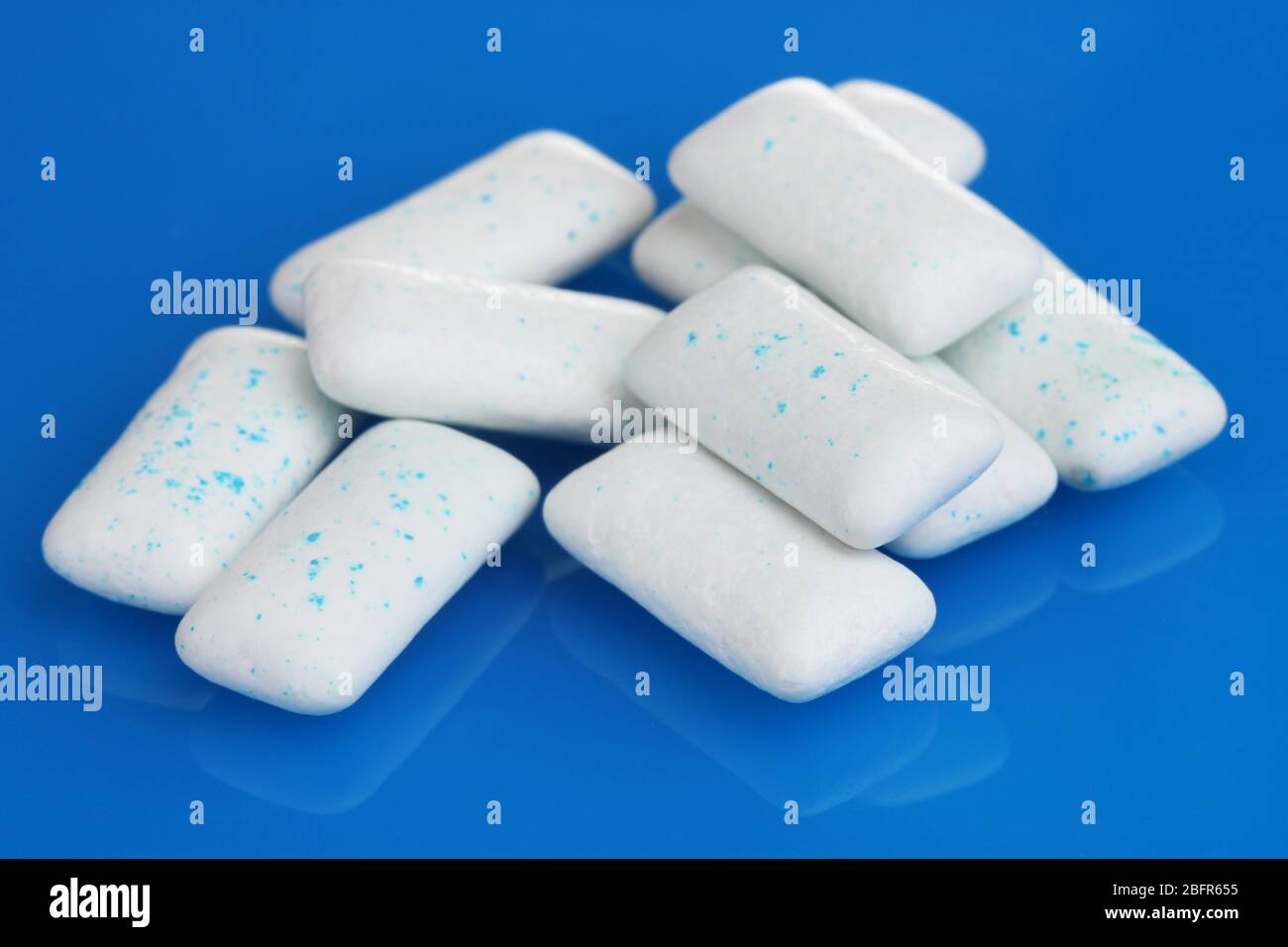 chewing gums on blue background Stock Photo - Alamy