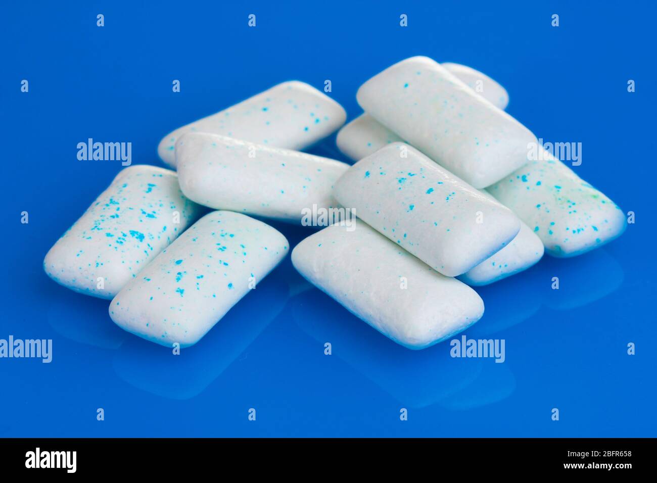 chewing gums on blue background Stock Photo - Alamy