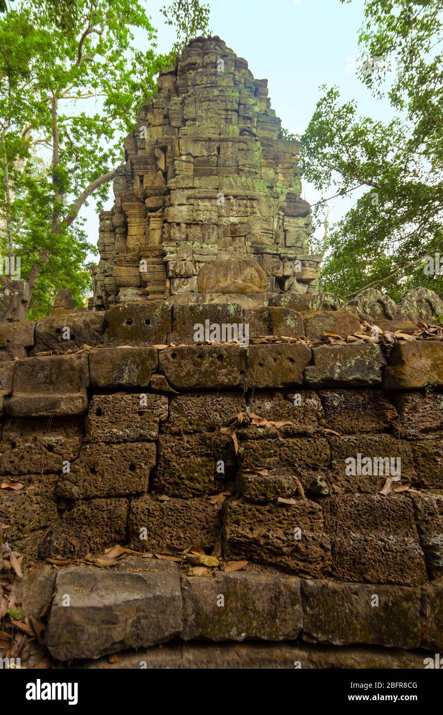 Collapsed stone wall overgrown by tree roots in famous Ta Phrom "Tomb ...