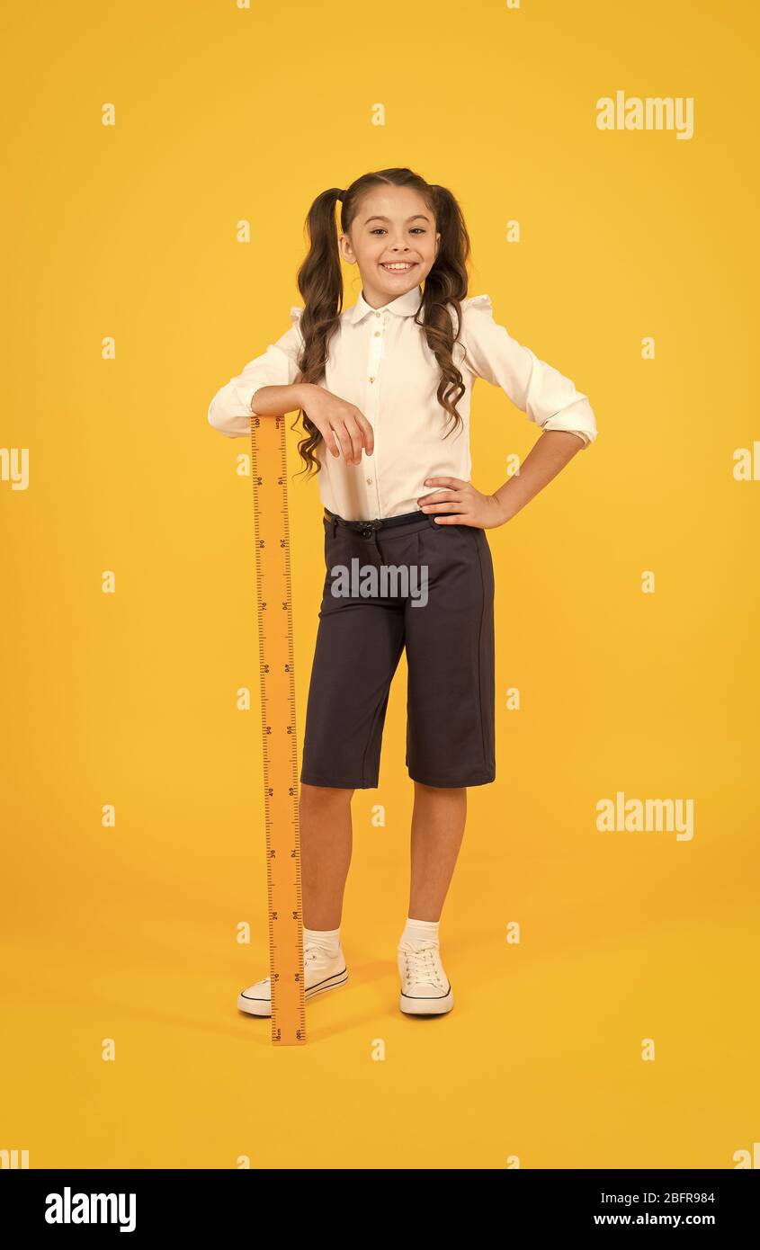 Education and school concept. Sizing and measuring. Pupil cute girl ...