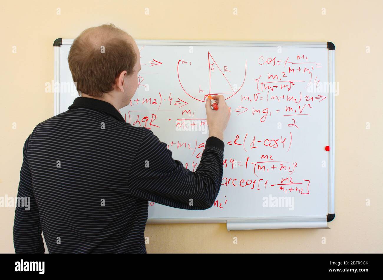 man writing math formulas on a white-board Stock Photo - Alamy