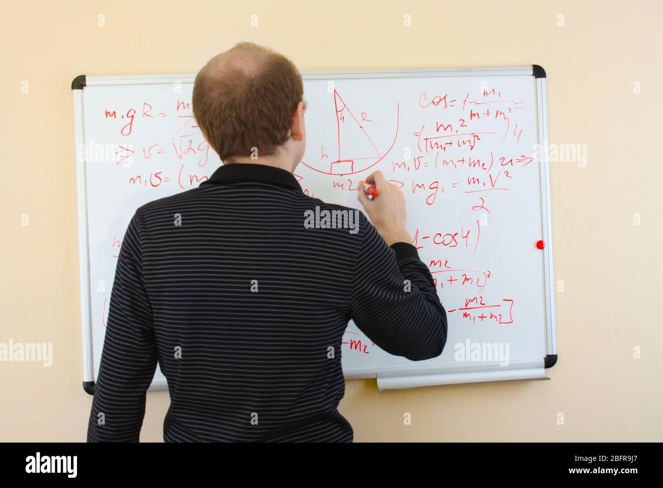 man writing math formulas on a white-board Stock Photo - Alamy