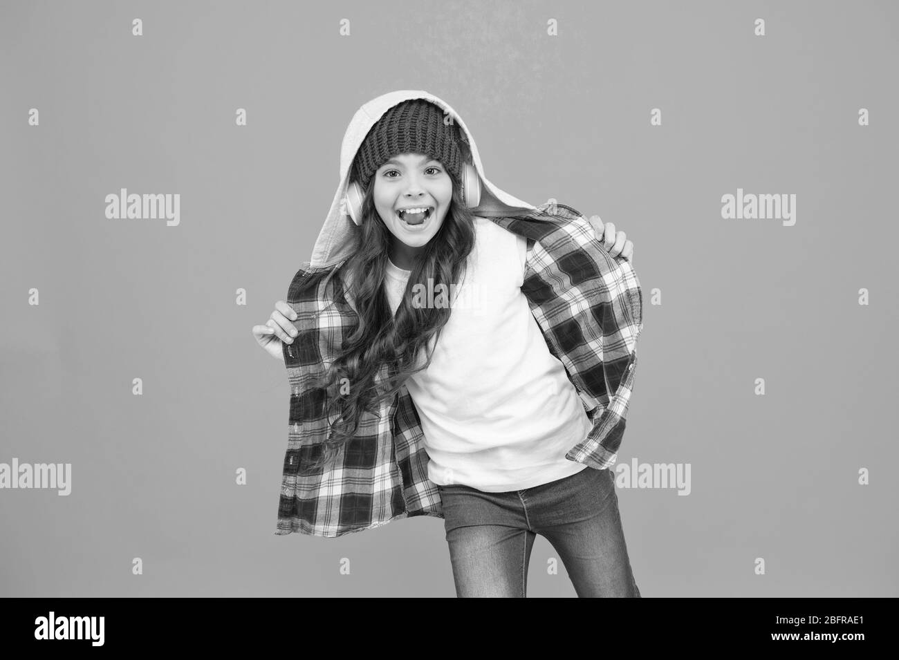 hip hop girl. small child long hair wireless headset. happy childhood ...