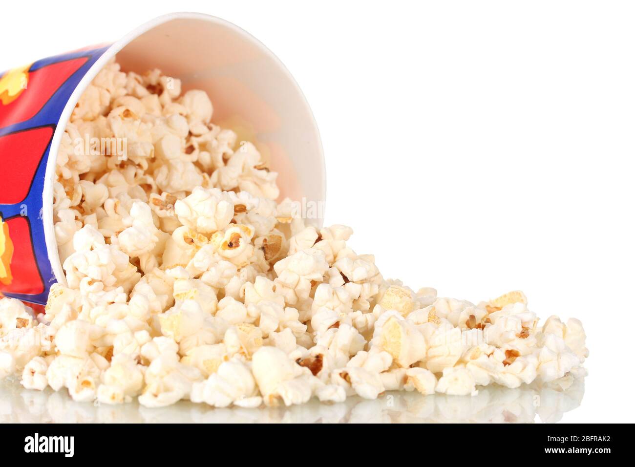 Full bucket of popcorn dropped isolated on white Stock Photo - Alamy
