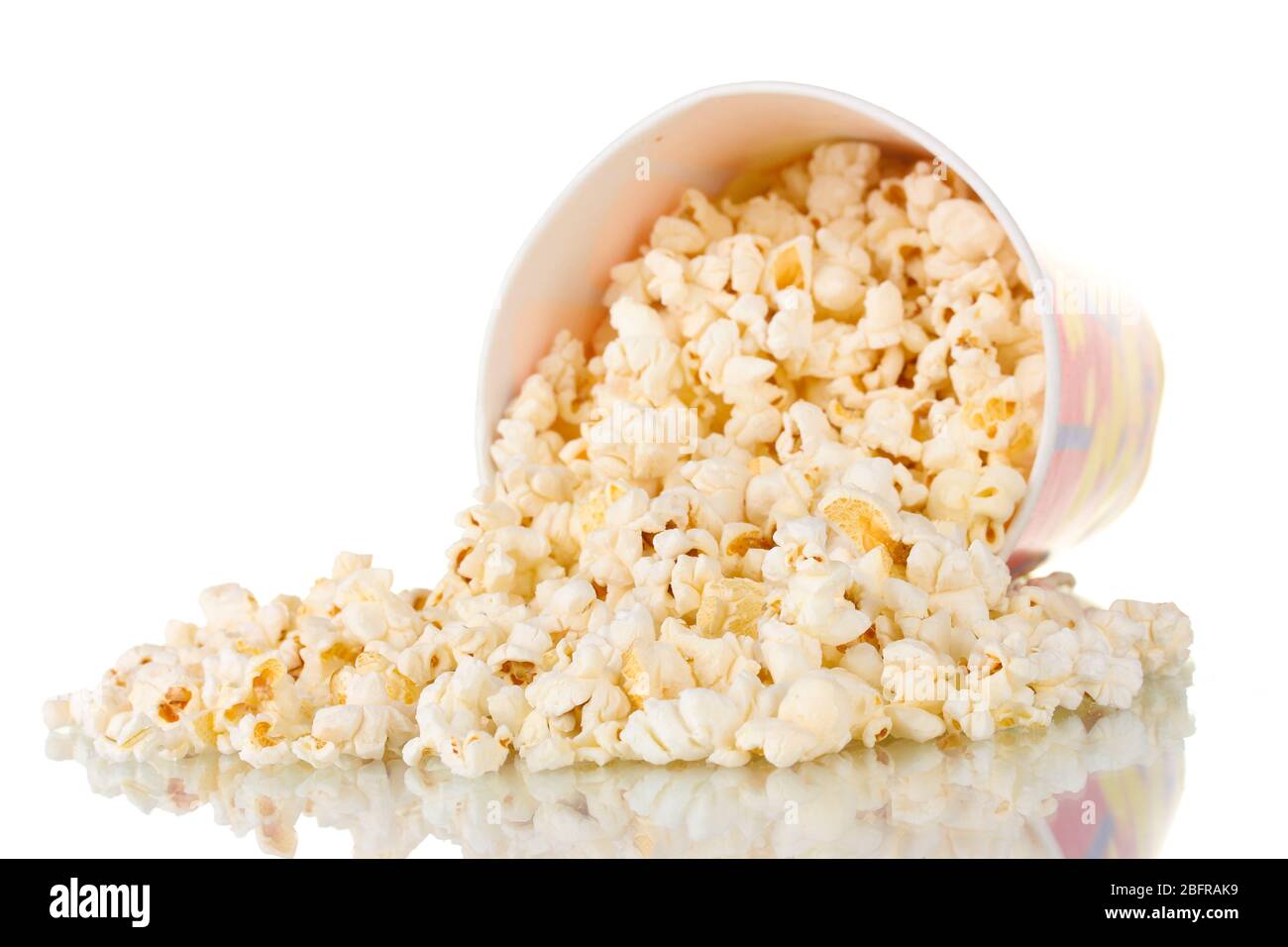 Full bucket of popcorn dropped isolated on white Stock Photo - Alamy
