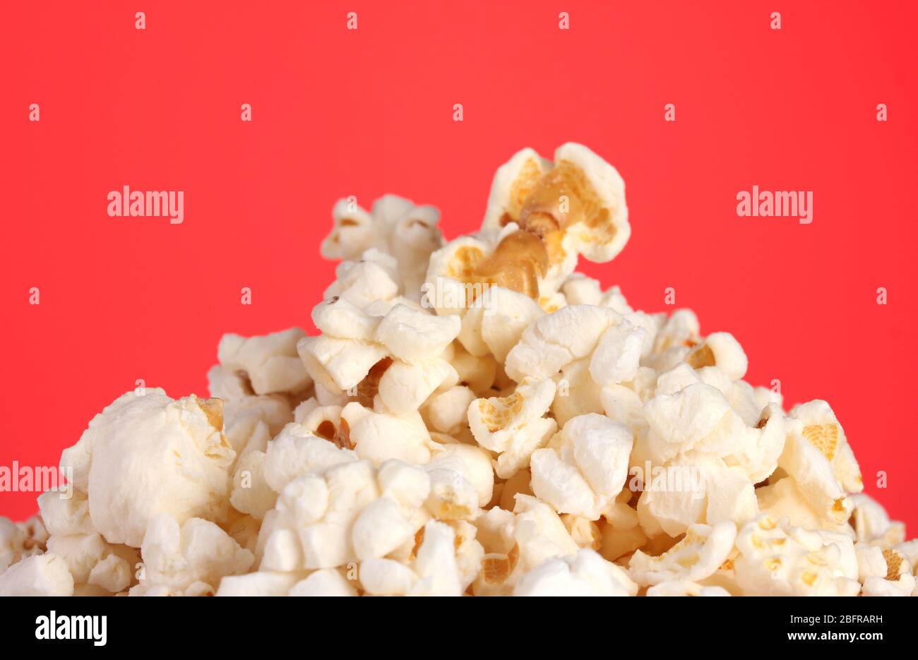Popcorn on red Stock Photo - Alamy