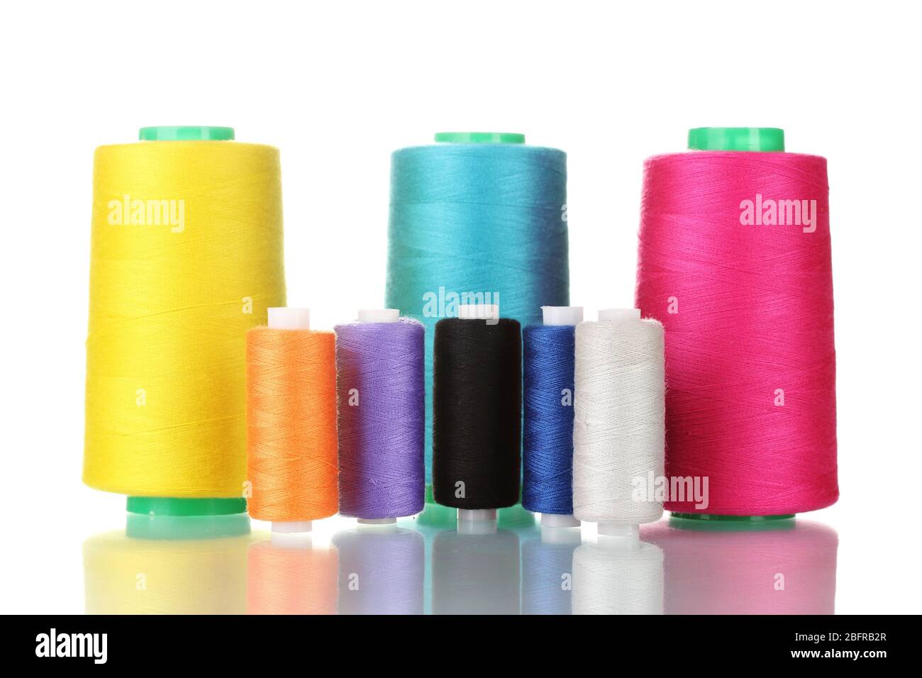 Many-coloured bobbins of thread isolated on white Stock Photo - Alamy