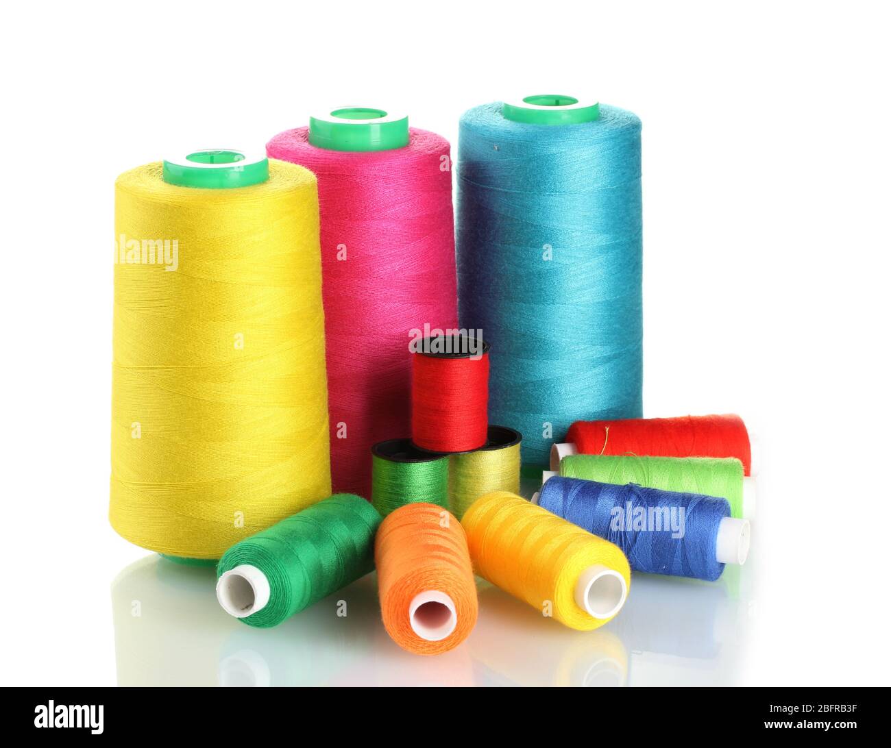 Many-coloured bobbins of thread isolated on white Stock Photo - Alamy