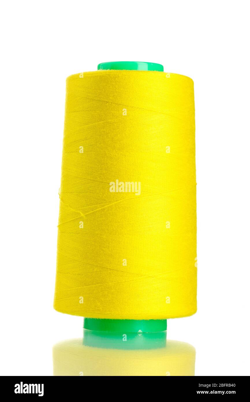 Yellow bobbin thread isolated on white Stock Photo - Alamy