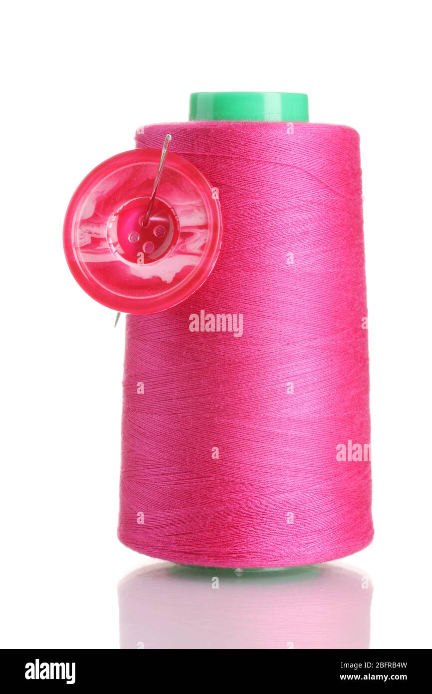 Pink bobbin thread with needle and pink button isolated on white Stock ...