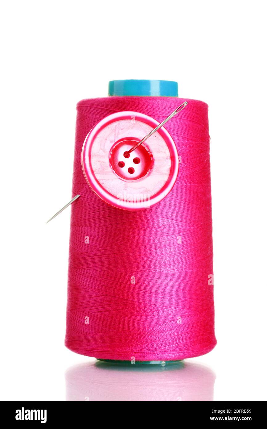 Pink bobbin thread with needle and pink button isolated on white Stock ...