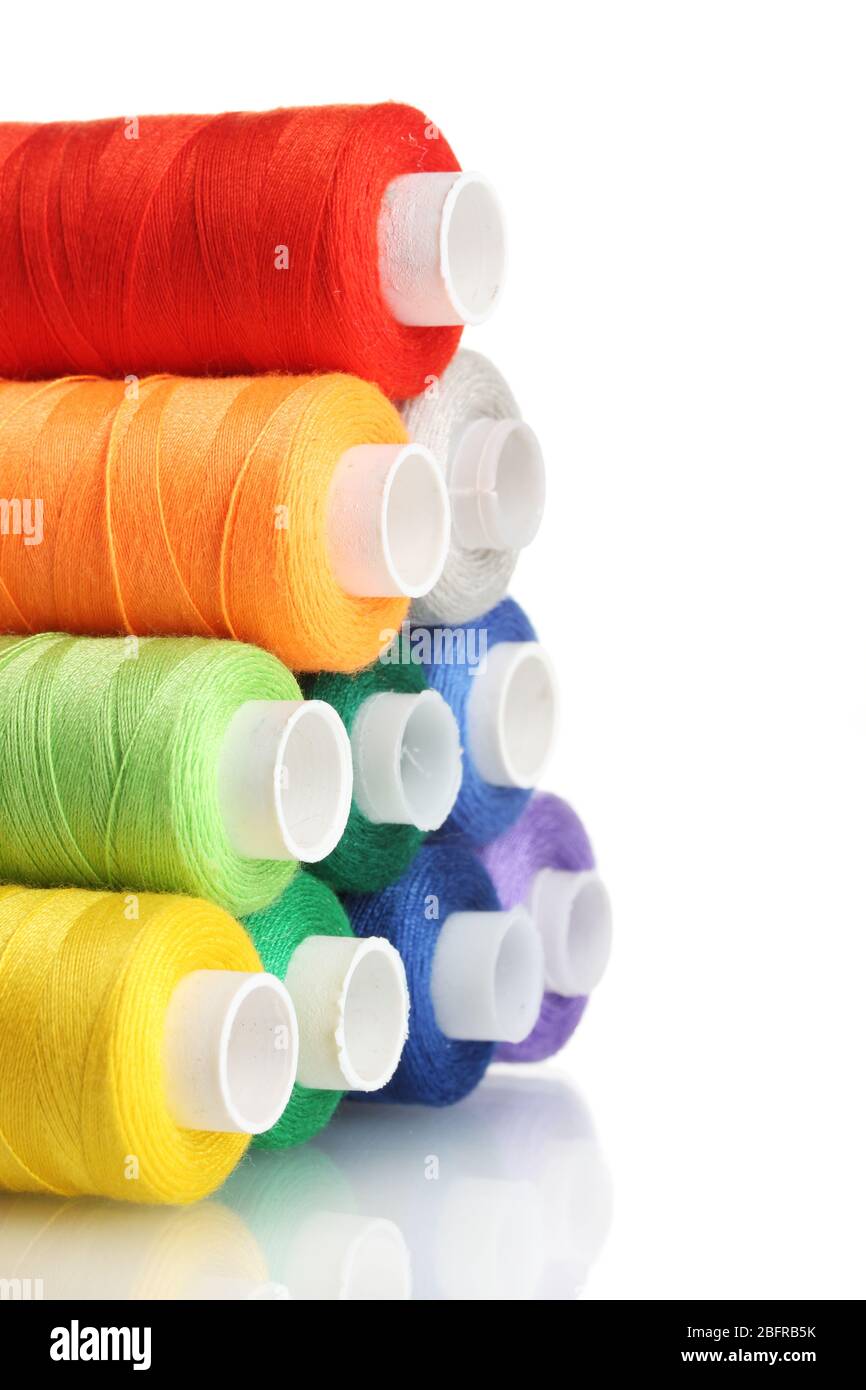 Pyramid of many-coloured bobbins of thread isolated on white Stock ...