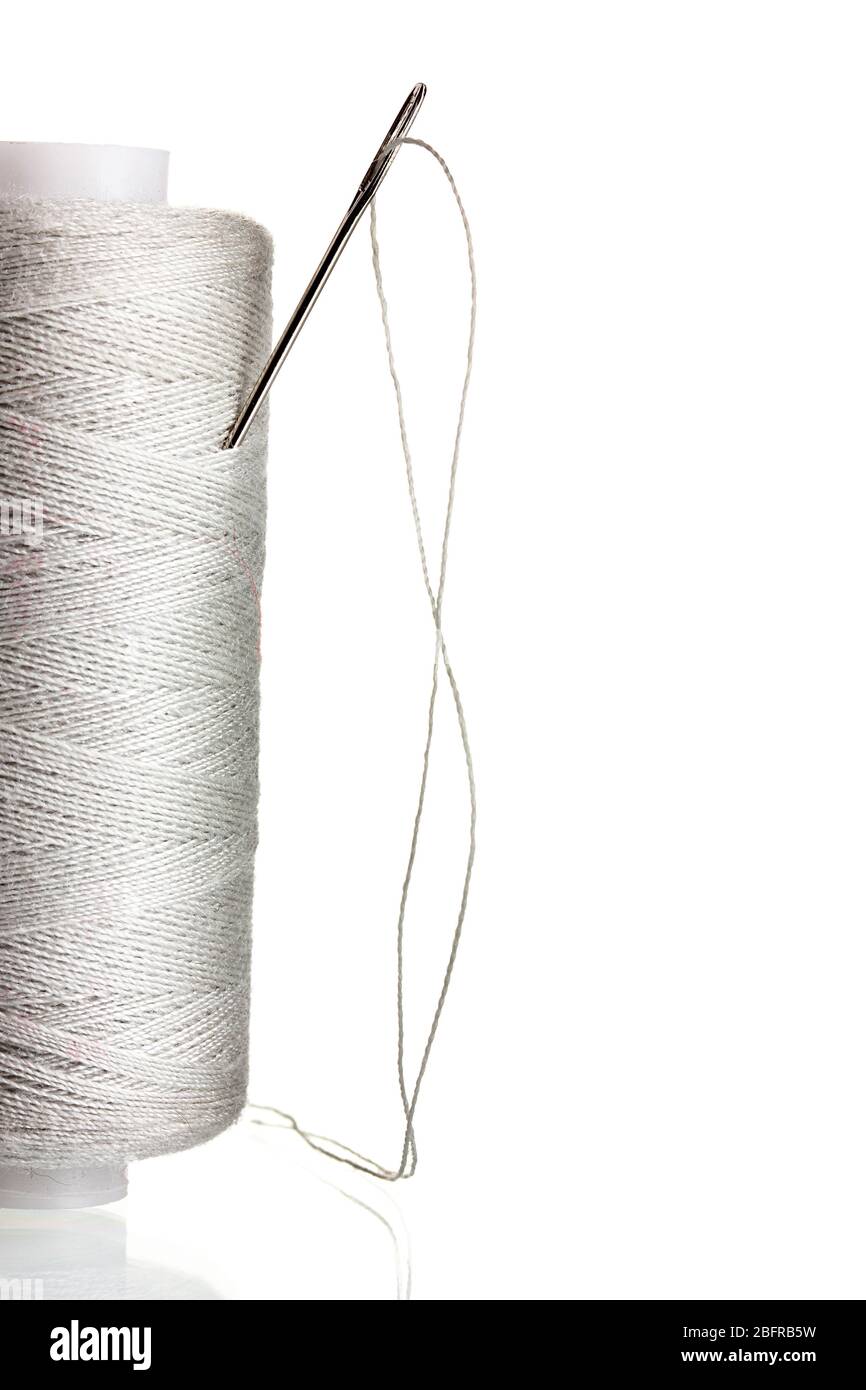White bobbin with needle isolated on white Stock Photo - Alamy