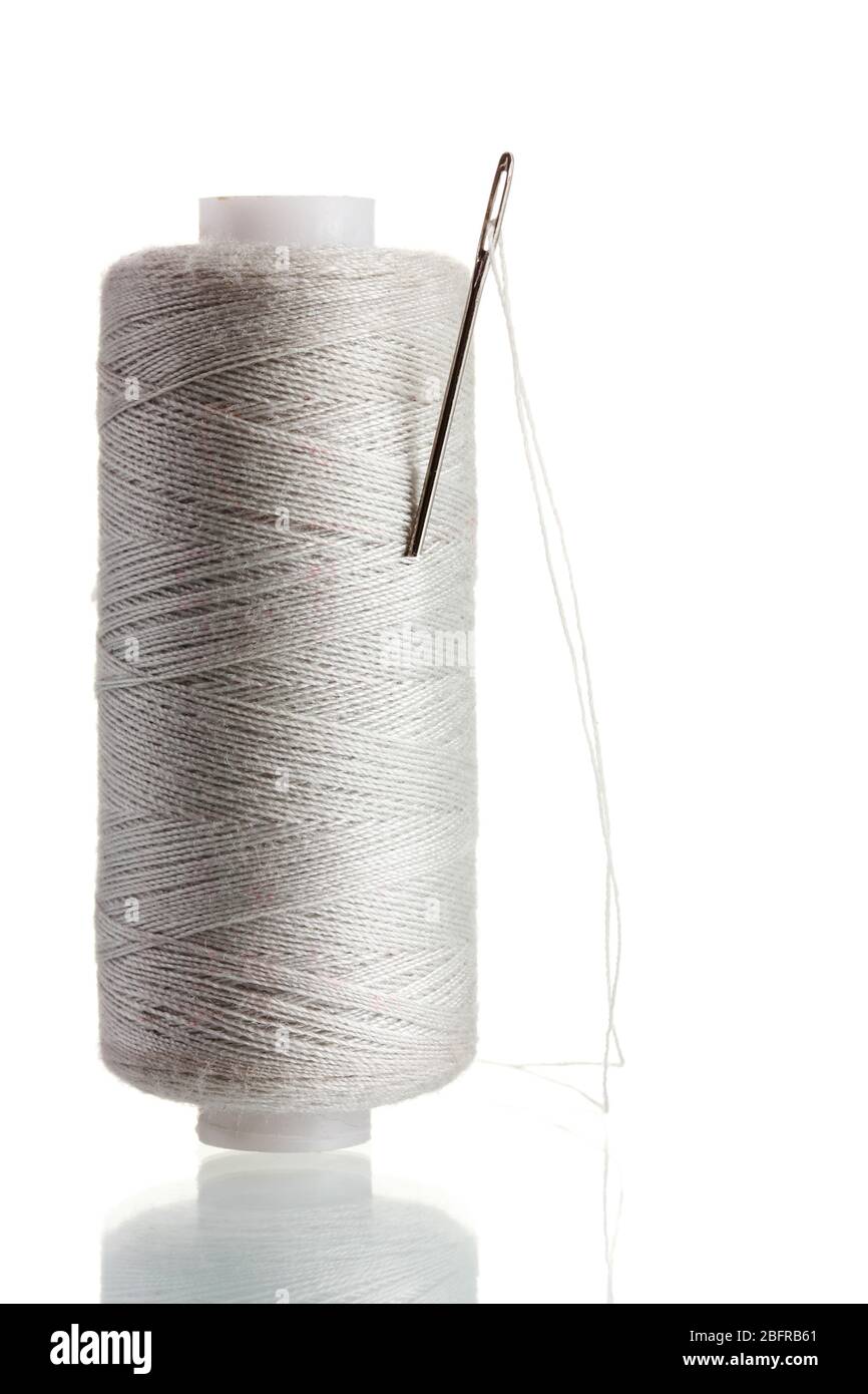 White bobbin with needle isolated on white Stock Photo - Alamy