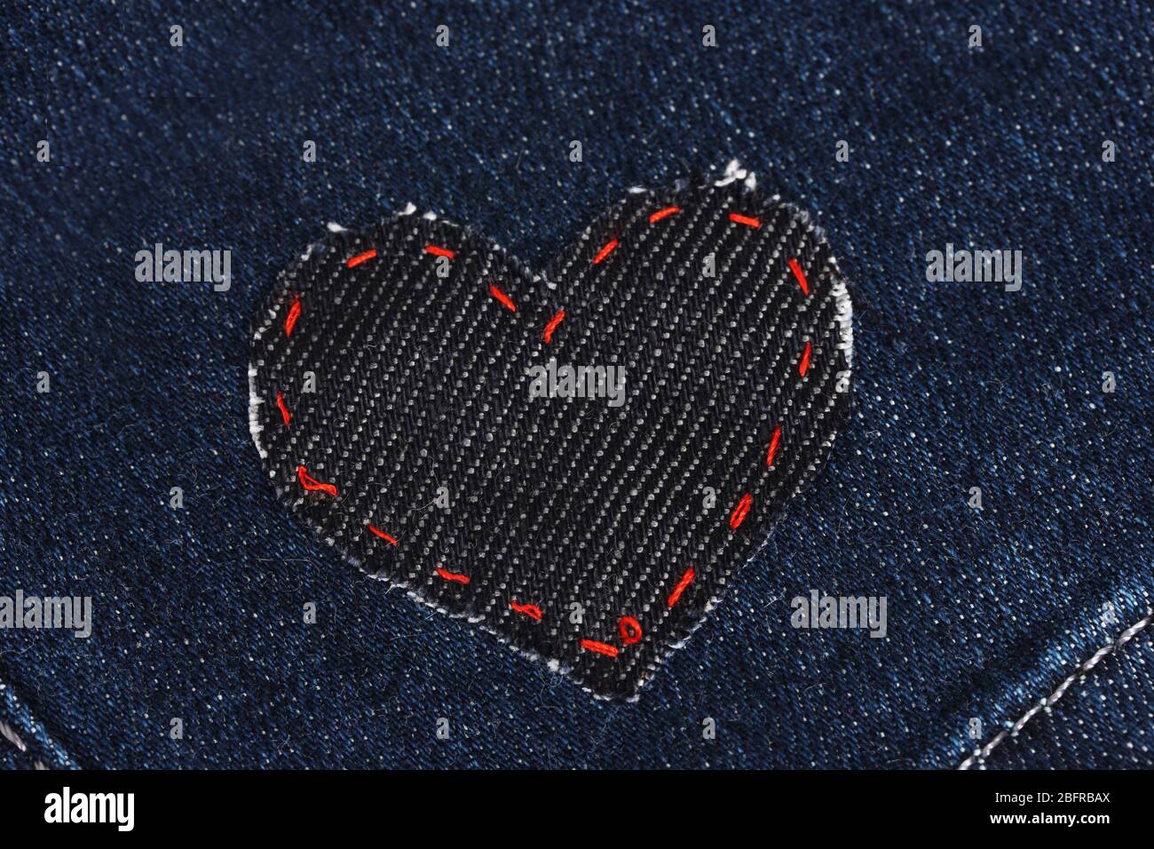 Heart-shaped patch on jeans closeup Stock Photo - Alamy
