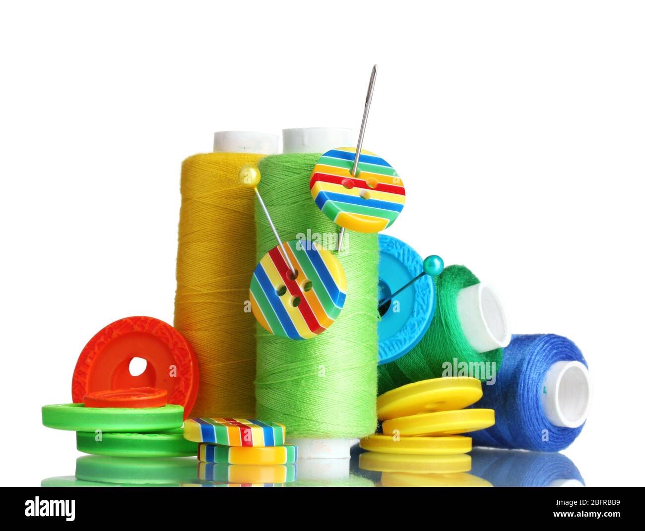 Many bobbin of thread with needle and buttons isolated on white Stock ...