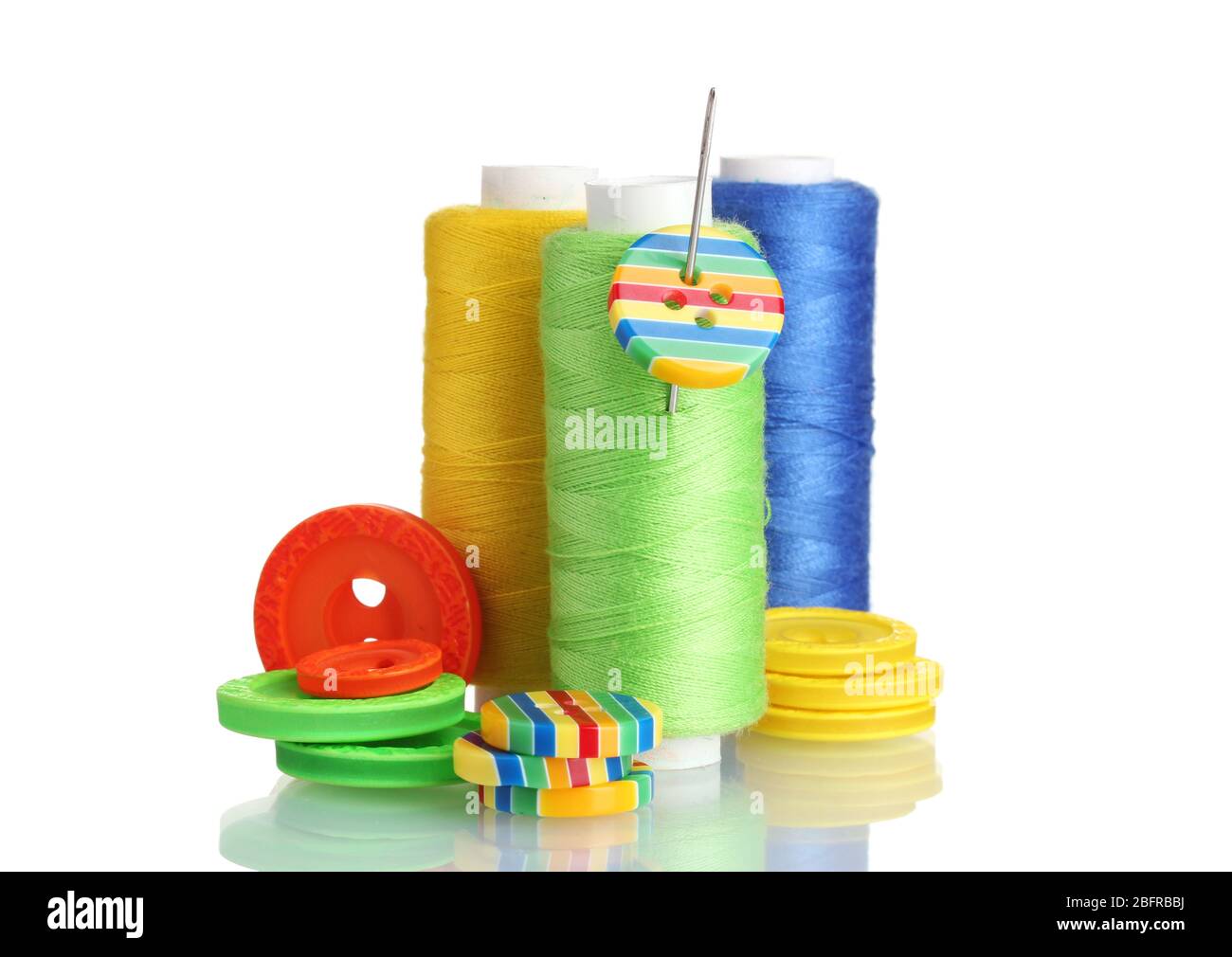 Many bobbin of thread with needle and buttons isolated on white Stock ...