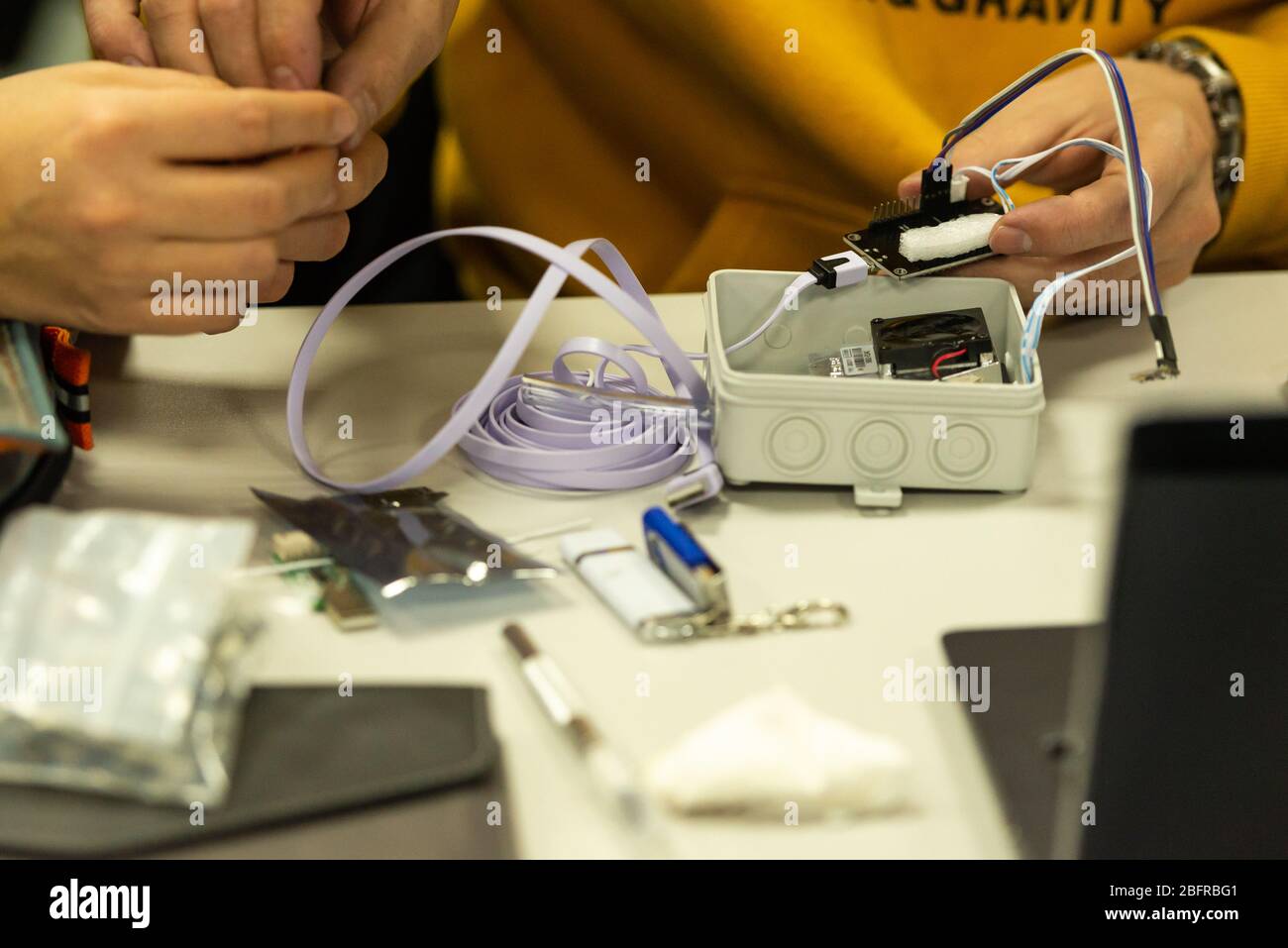 Assembling the weather sensor. Small electronics are assembled and sewn ...