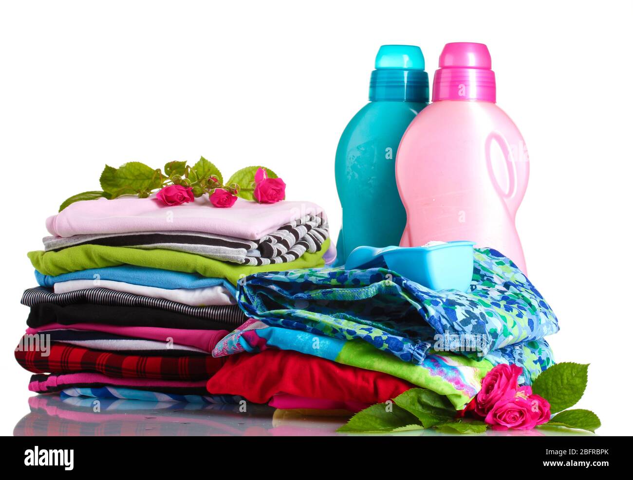Detergent with washing powder and pile of colorful clothes isolated on ...
