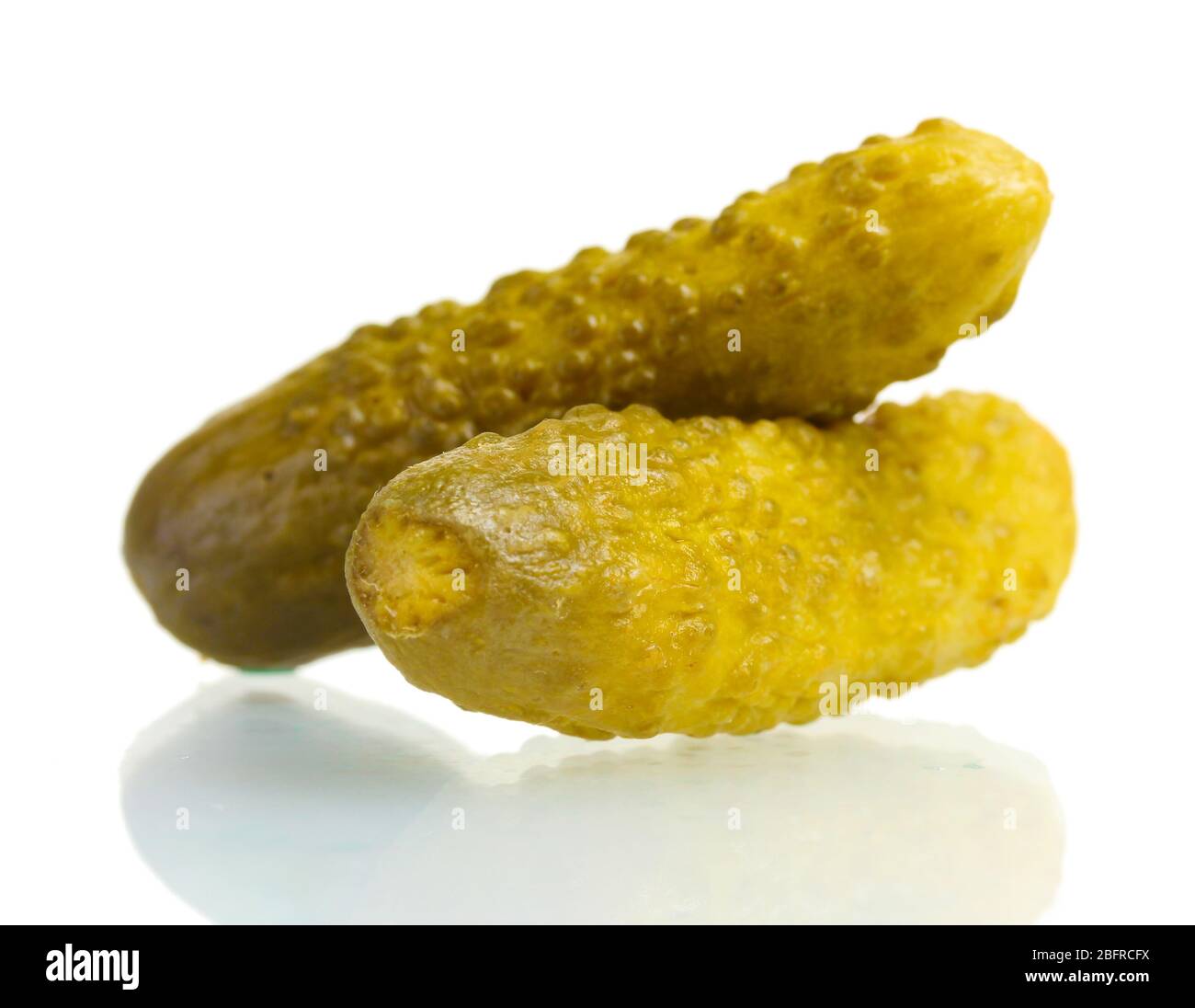 Two marinated cucumbers isolated on white Stock Photo - Alamy