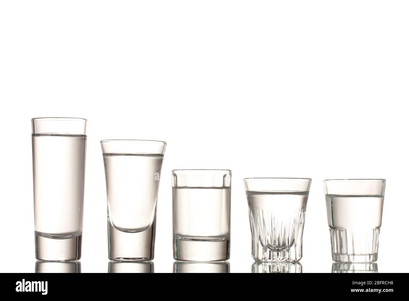 Many glass of vodka isolated on white Stock Photo - Alamy