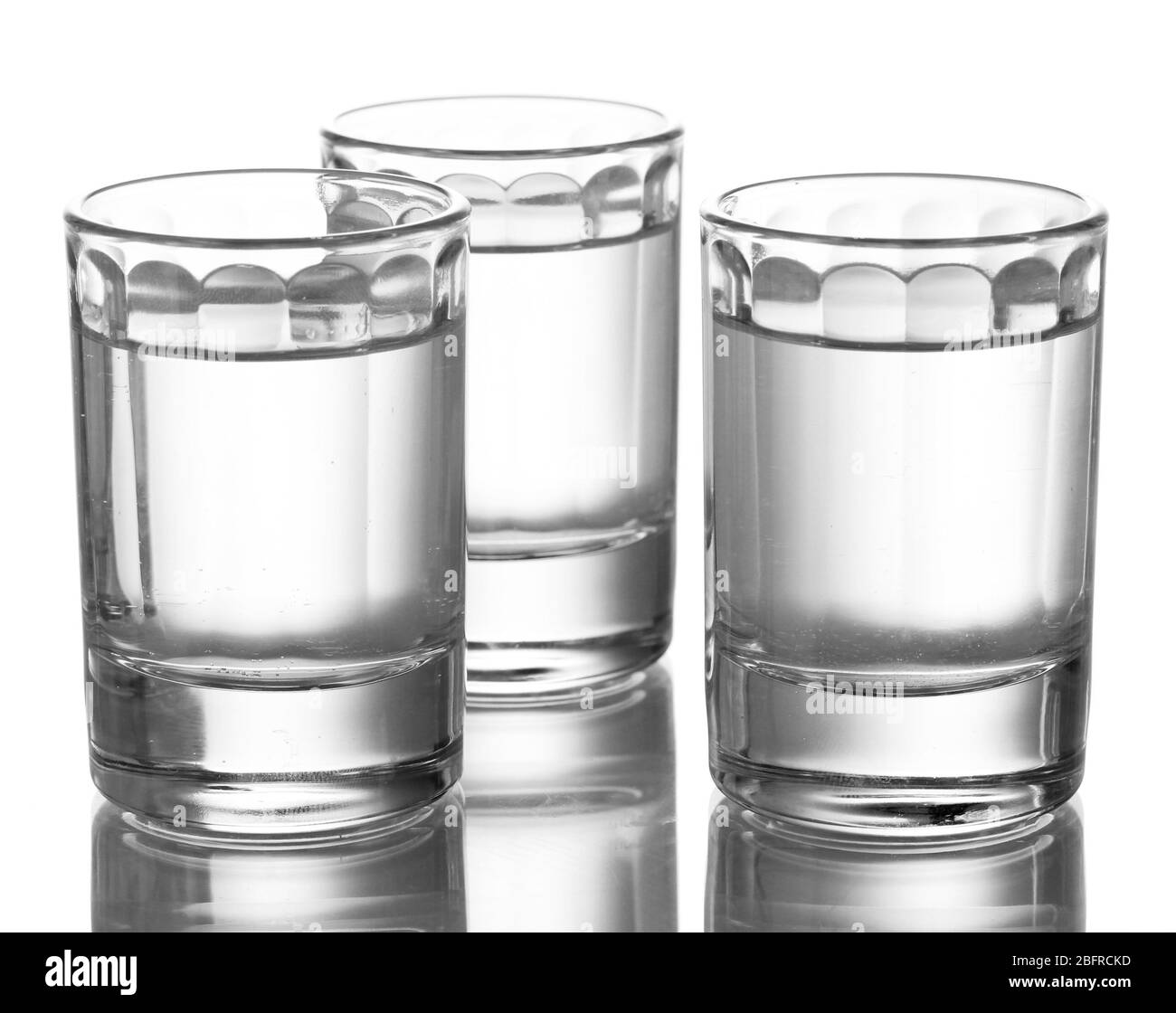 Three glass of vodka isolated on white Stock Photo - Alamy