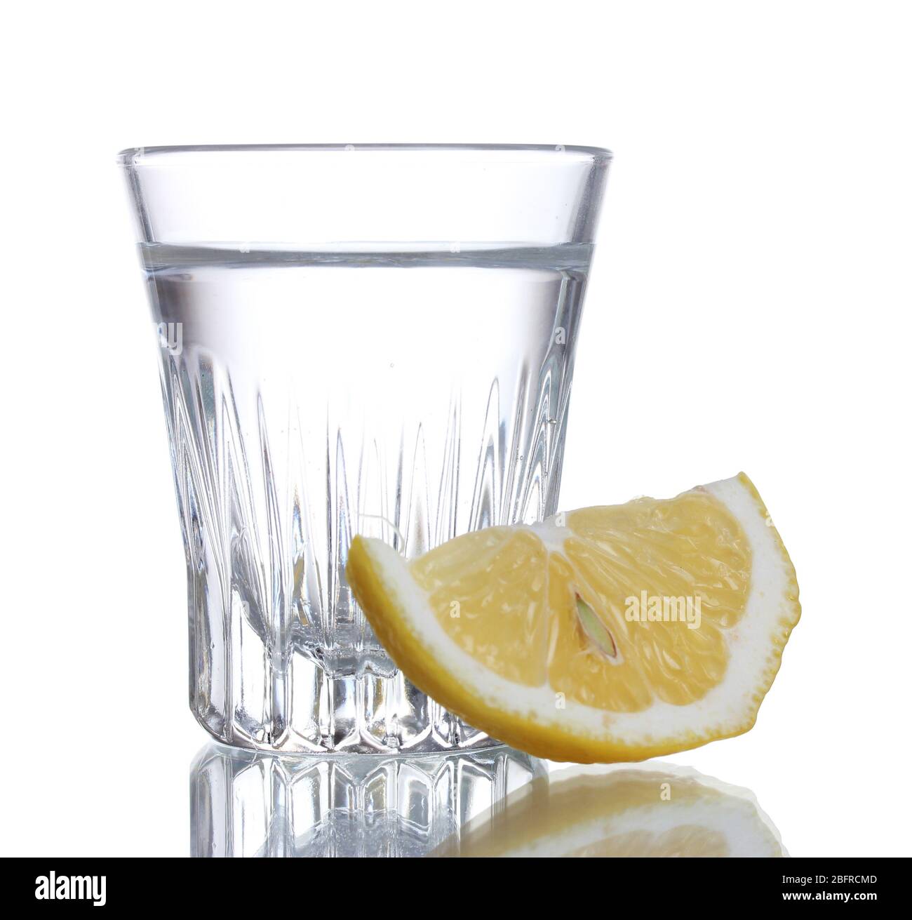 Glass of vodka with lemon isolated on white Stock Photo - Alamy