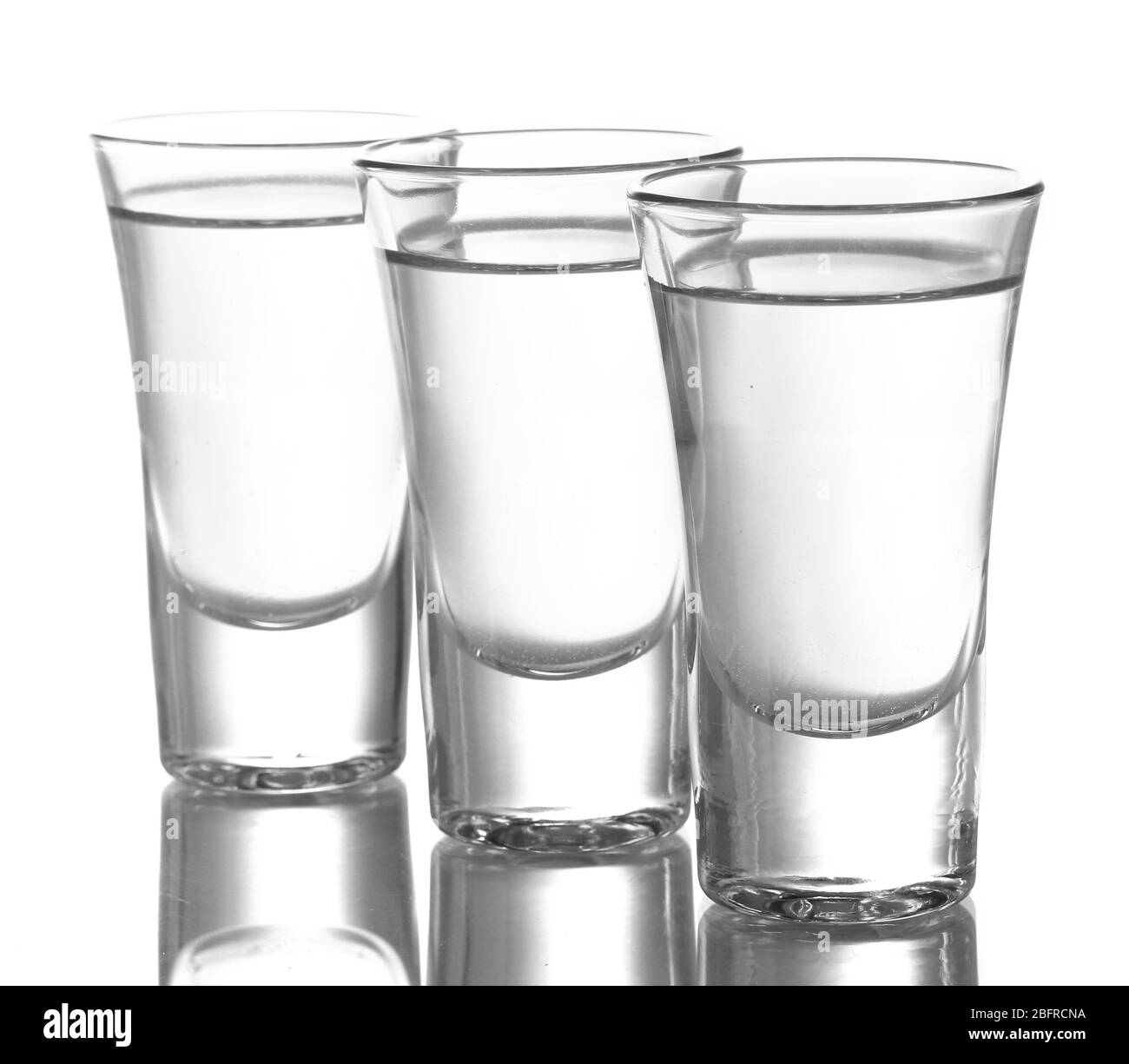 Three glass of vodka isolated on white Stock Photo - Alamy