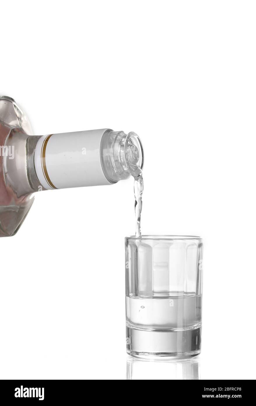 Vodka poured into a glass isolated on white Stock Photo - Alamy