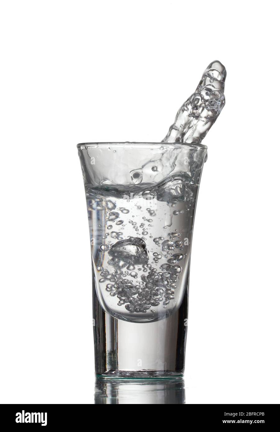 Vodka poured into a glass isolated on white Stock Photo - Alamy