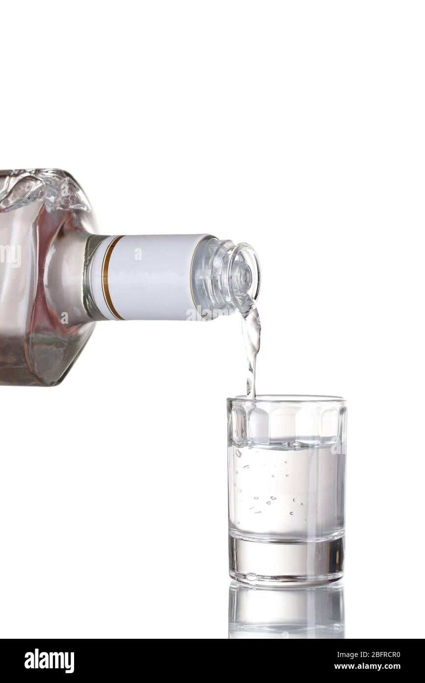 Vodka poured into a glass isolated on white Stock Photo - Alamy