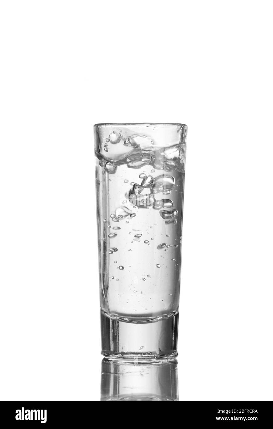 Vodka poured into a glass isolated on white Stock Photo - Alamy