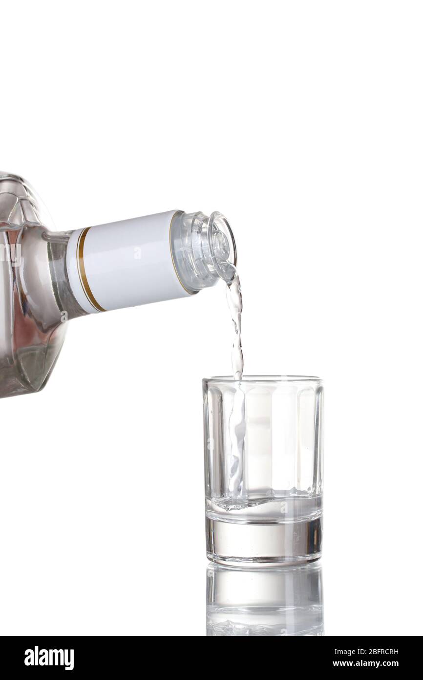 Vodka poured into a glass isolated on white Stock Photo - Alamy